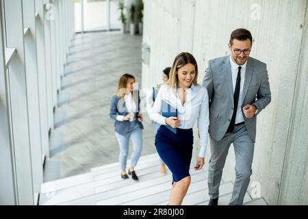 Young startup team have a discussion while climbing on the stairs in ...