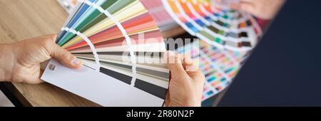 Creative designer advises client and shows color sample in color ...