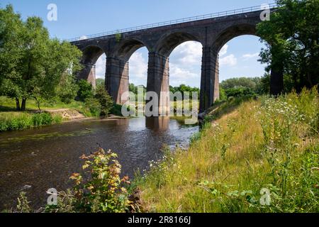 Railway viaduct over the river Tame at Reddish Vale country park ...