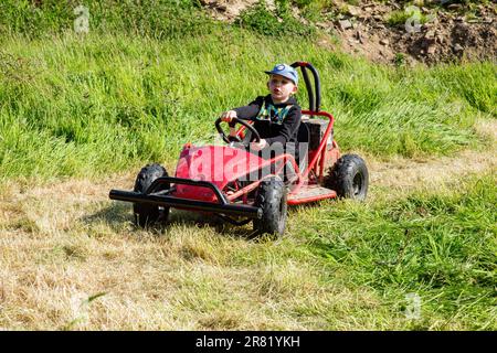 Electric powered Go-Kart racing around a field, High Bickington, North ...
