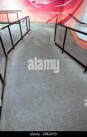Handicapped down ramp with urban art on walls Stock Photo - Alamy