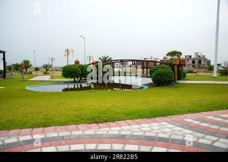 A public park in Kharian City, Pakistan, with a wooden bridge and ...