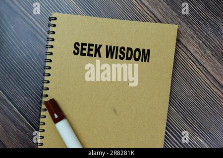 Concept of Seek Wisdom write on sticky notes isolated on Wooden Table ...