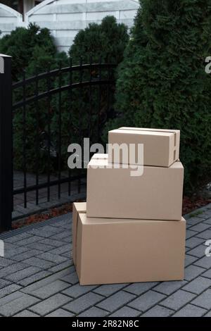 Stack of parcels delivered near front gates Stock Photo - Alamy