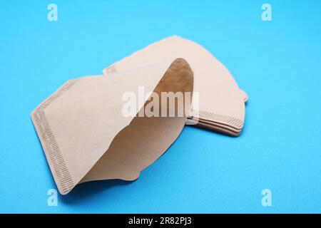 Paper coffee filters on light blue background, flat lay Stock Photo - Alamy