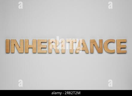 Word Inheritance made with wooden letters and houses model on black ...