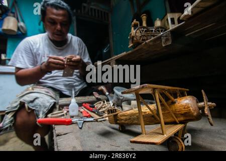 A craftsman makes automotive miniatures from bamboo in Bogor, West Java ...