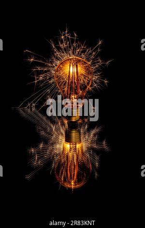 Burning sparkler behind a lightbulb Stock Photo - Alamy