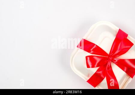 Closed bento cake box with tied red ribbon. Gift box with tasty bento ...