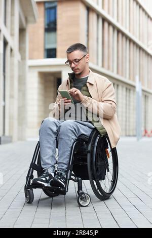Young man texting while sitting on bench, Vancouver, Canada Stock Photo ...