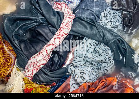 Laundry soaked in water is ready for washing procedure Stock Photo - Alamy