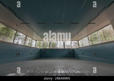 Old swimming pool or indoor pool without water which is no longer used ...