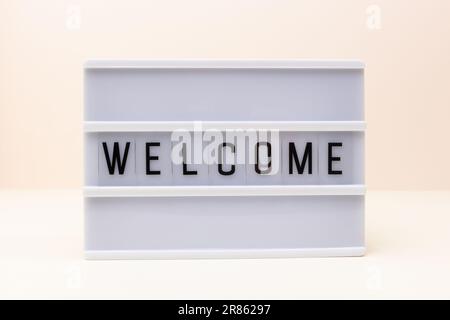 Word Welcome. Lightbox with letters in front of pink background. Place ...