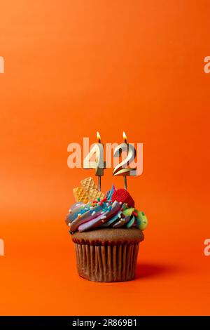 Birthday cake with candle number 42 - Blue background Stock Photo - Alamy