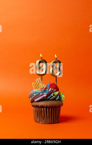 birthday cake with number 98 - cupcake on orange background with ...