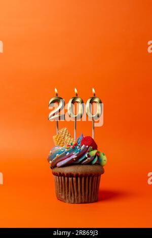 Candle number 200 - Celebration with birthday cupcake on orange ...