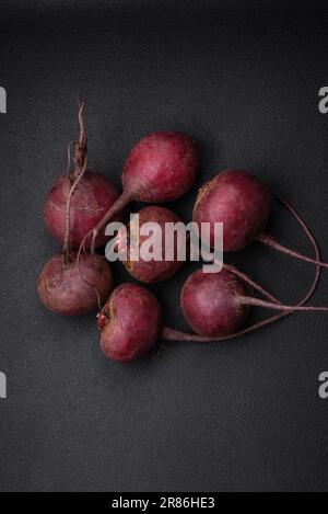 Fresh raw beetroot in the form of tubers on a textured concrete ...
