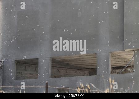 A view of the wall of a house riddled with bullets during a raid on the ...