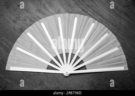 Stylish white hand fan on light blue background, top view. Space for ...