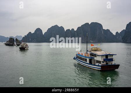 An aerial view of cruise ships navigating through Halong Bay in Vietnam ...