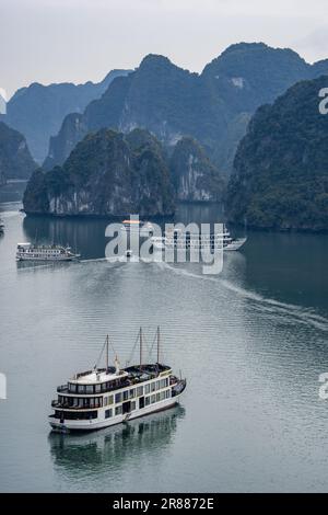An aerial view of cruise ships navigating through Halong Bay in Vietnam ...