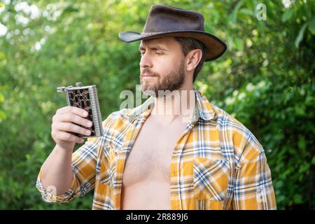 masculine cowboy with flask outdoor. masculine cowboy with flask wear ...