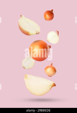 Cut onions falling on pastel light blue background Stock Photo - Alamy