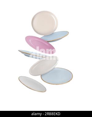 Many different plates falling on white background Stock Photo - Alamy