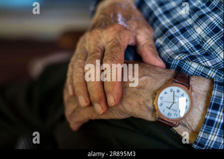 Time-worn watches on elder's wrists of very old man and grandfather ...