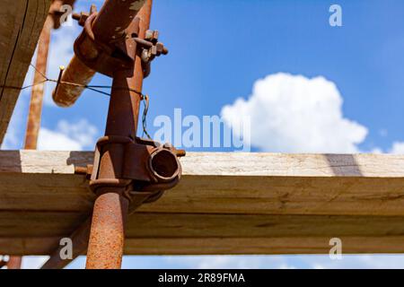 Joint of steel rusty scaffolding with tread, wooden plank for trampling ...