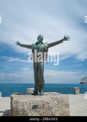 Bronze statue of the Italian singer Domenico Modugno facing the old ...