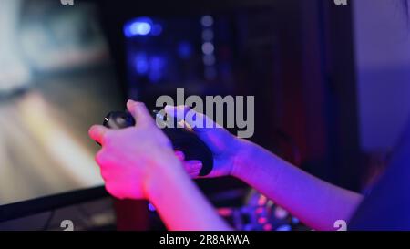 Hand of female cyber hacker gamer holding controller joystick to ...