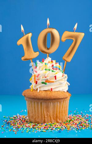 Candle number 107 - Cake birthday in orange background Stock Photo - Alamy