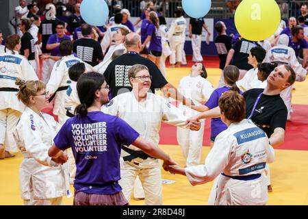Judo athletes together with judges and collunters go through the ...