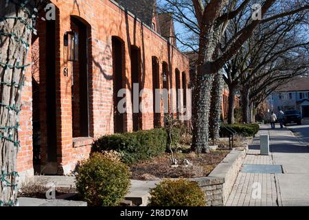 Brick Townhouse with Trees Infront Stock Photo - Alamy