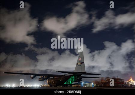 Cargo is offloaded from a C-130H assigned to the 75th Expeditionary ...