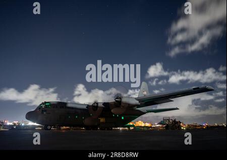 Cargo is offloaded from a C-130H assigned to the 75th Expeditionary ...