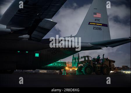 Cargo is offloaded from a C-130H assigned to the 75th Expeditionary ...