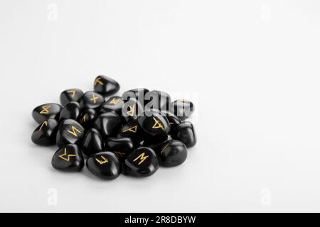 Black rune stones on white background, top view Stock Photo - Alamy