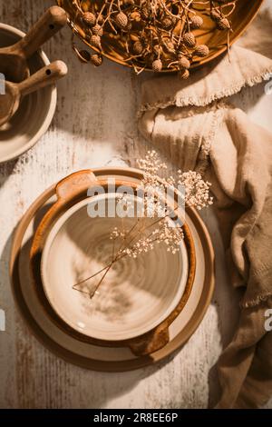 Set of kitchen ceramic tableware and wooden cutting boards on a table ...