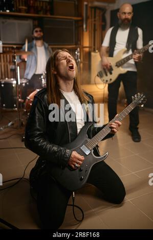 Repetition of rock music band inside home garage and expressive ...