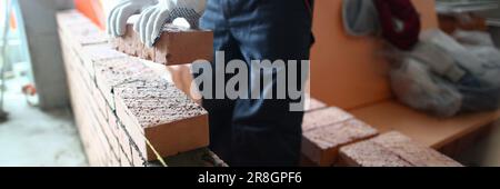 A closeup of a person laying bricks in a construction site Stock Photo ...