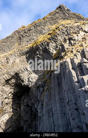Detail of a mountain with a cave, located on a beach. Fascinating ...