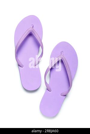 Pair of lilac flip-flops on white background Stock Photo - Alamy