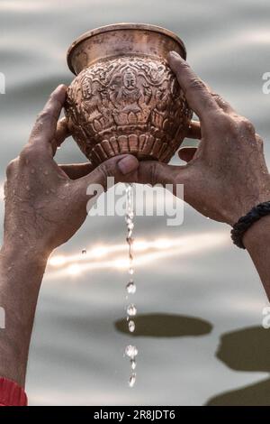 A Hindu devotee offers prayers in the Rivers Ganges on Ganga Dussehra ...