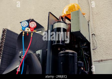 Broken external air conditioner unit with protection cover removed in ...