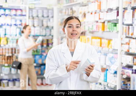 Female pharmacist offers various body care medicines Stock Photo - Alamy