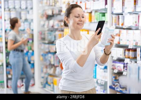 In pharmacy visitor scan QR Code and reads composition of cream for ...