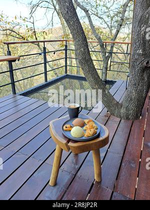 Breakfast on the terrace of a cabin in the woods on a wooden table with ...