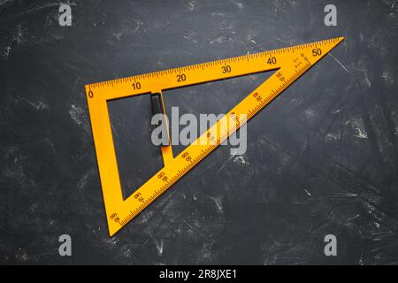 Triangle with measuring length markings on blackboard, top view. Space ...